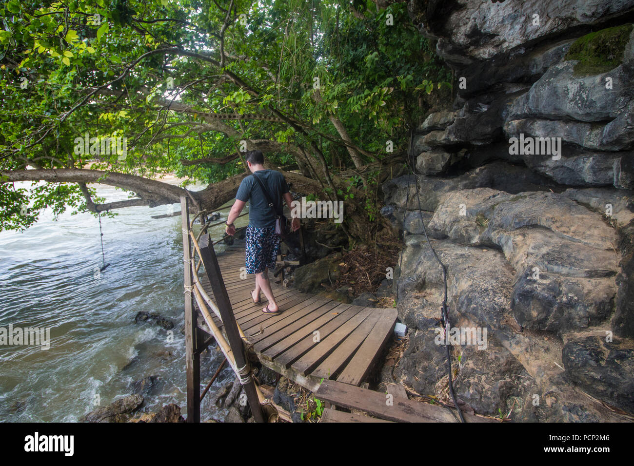 Cliffside wooden path over the water from Ao Nang beach to secluded ...
