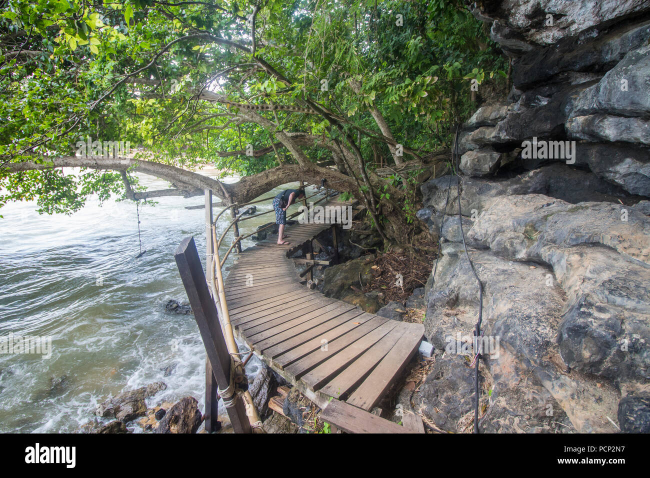 Cliffside wooden path over the water from Ao Nang beach to secluded ...