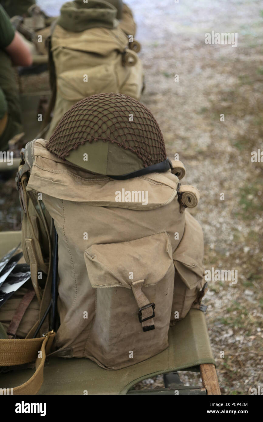 backpack and military helmet of the second world war on the cot of a ...