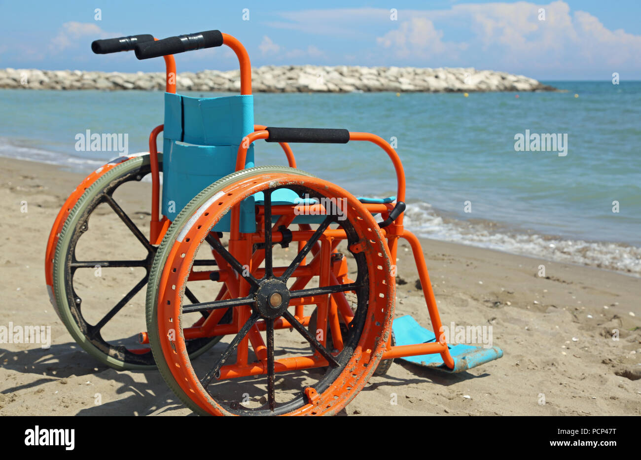special aluminum wheelchair with perforated wheels to go on the beach ...