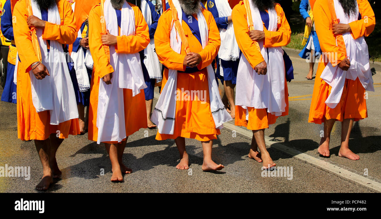 Sikh soldiers dressed in traditional orange clothes march barefoot ...