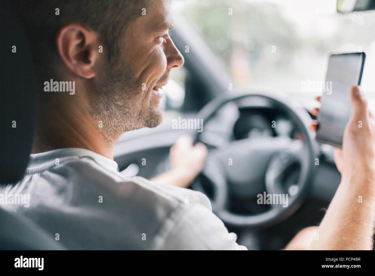 Careless driver using his mobile phone whilst driving a car Stock Photo ...