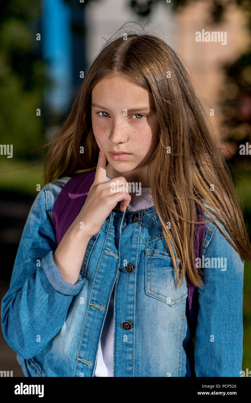 Close-up portrait of a beautiful teenager girl in summer outdoor. In ...