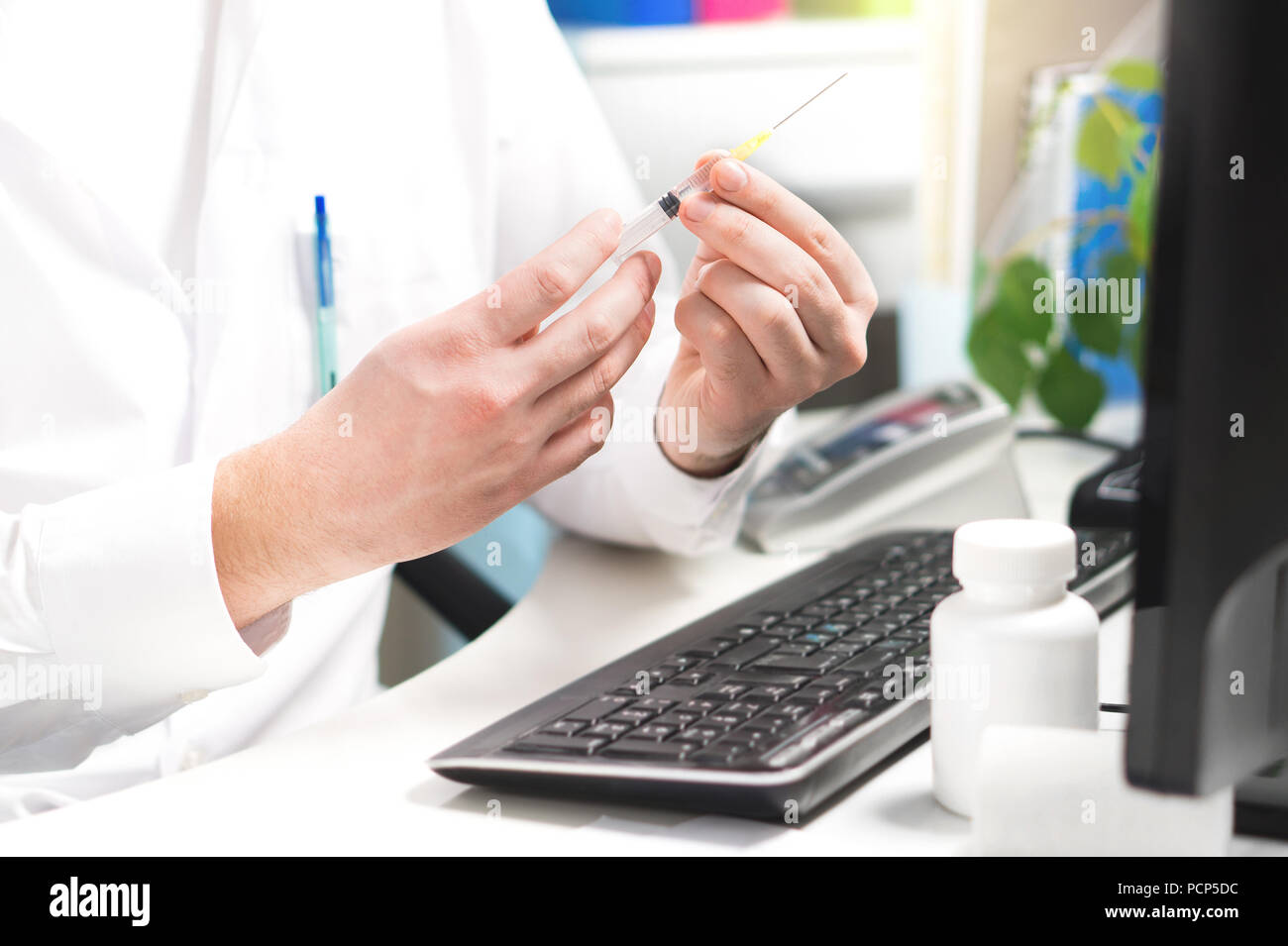 Doctor testing or preparing vaccine, flu or influenza shot or blood ...