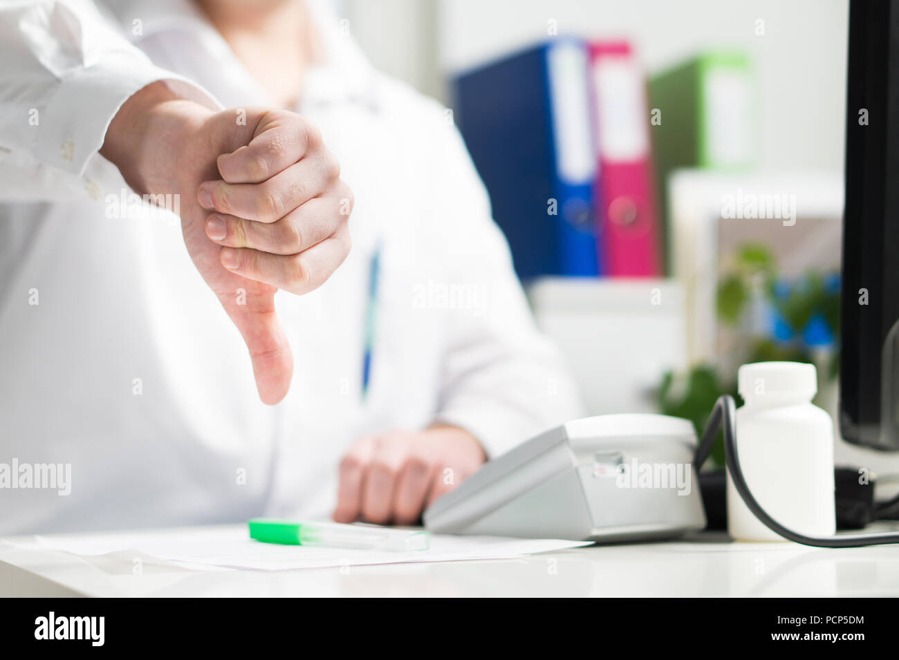 Doctor shows thumbs down. Sad or disappointed doc, medic, nurse or ...