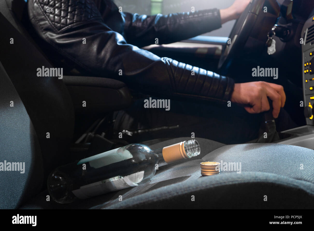 Drunk driving concept. Young man driving car under the influence of ...