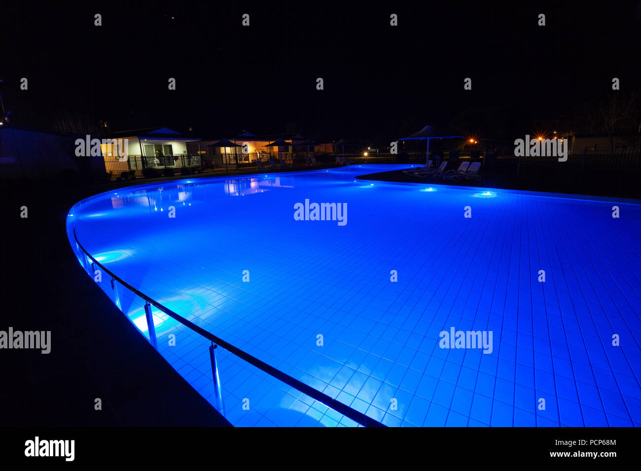 Swimming pool with blue lighting in luxury resort at night Stock Photo ...