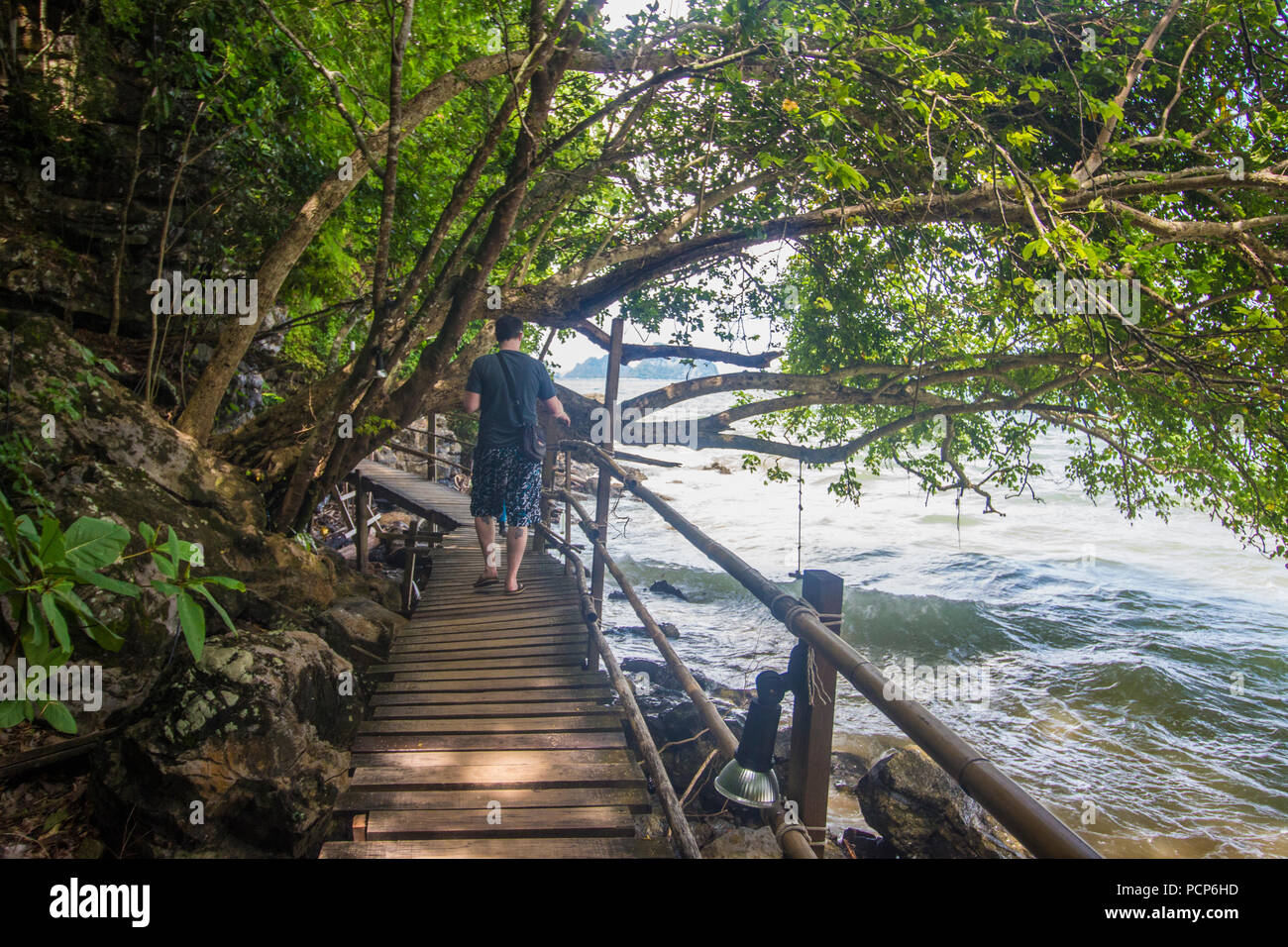 Cliffside wooden path over the water from Ao Nang beach to secluded ...
