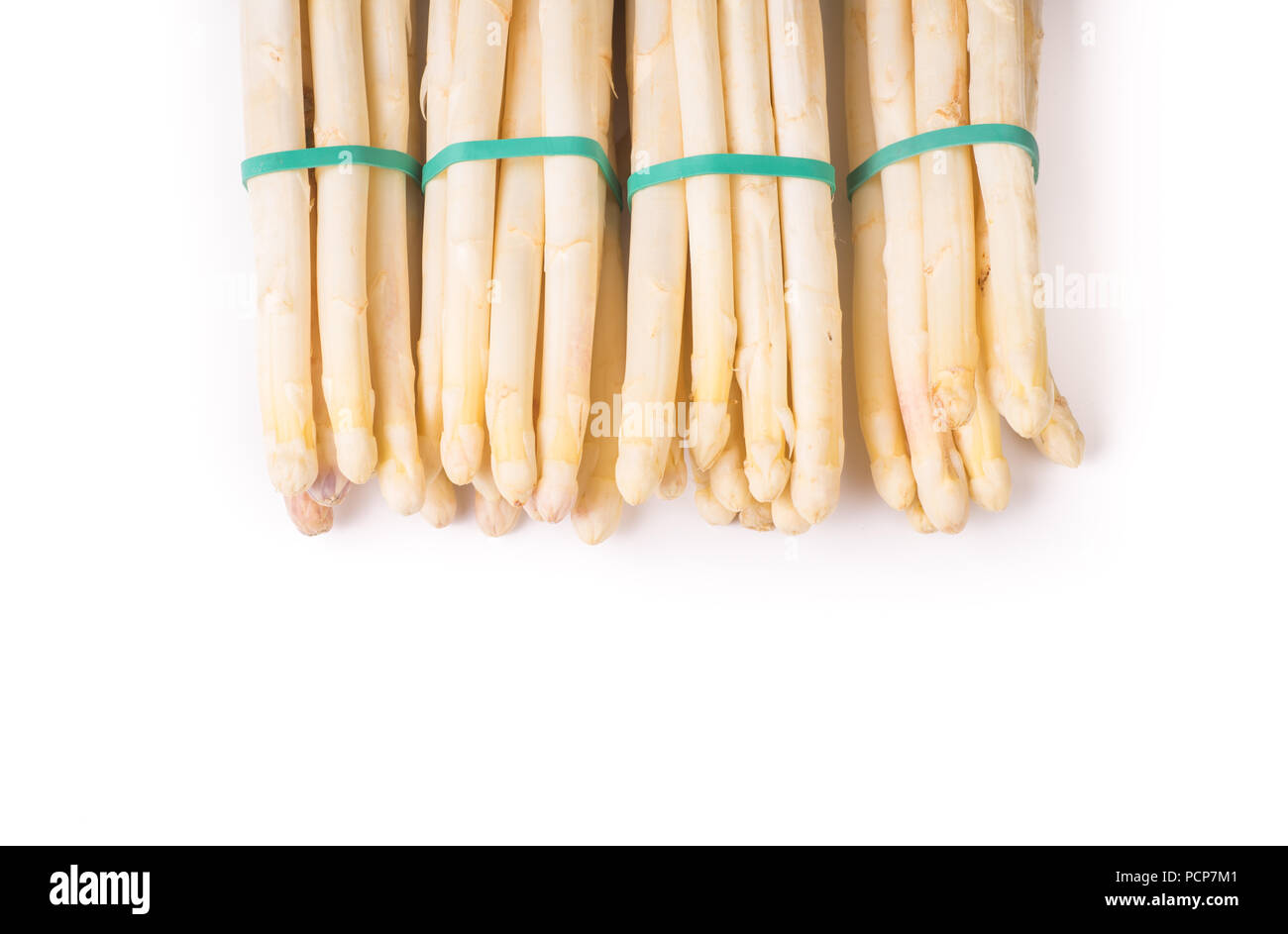 bundle of organic asparagus held together with green rubber bands ...