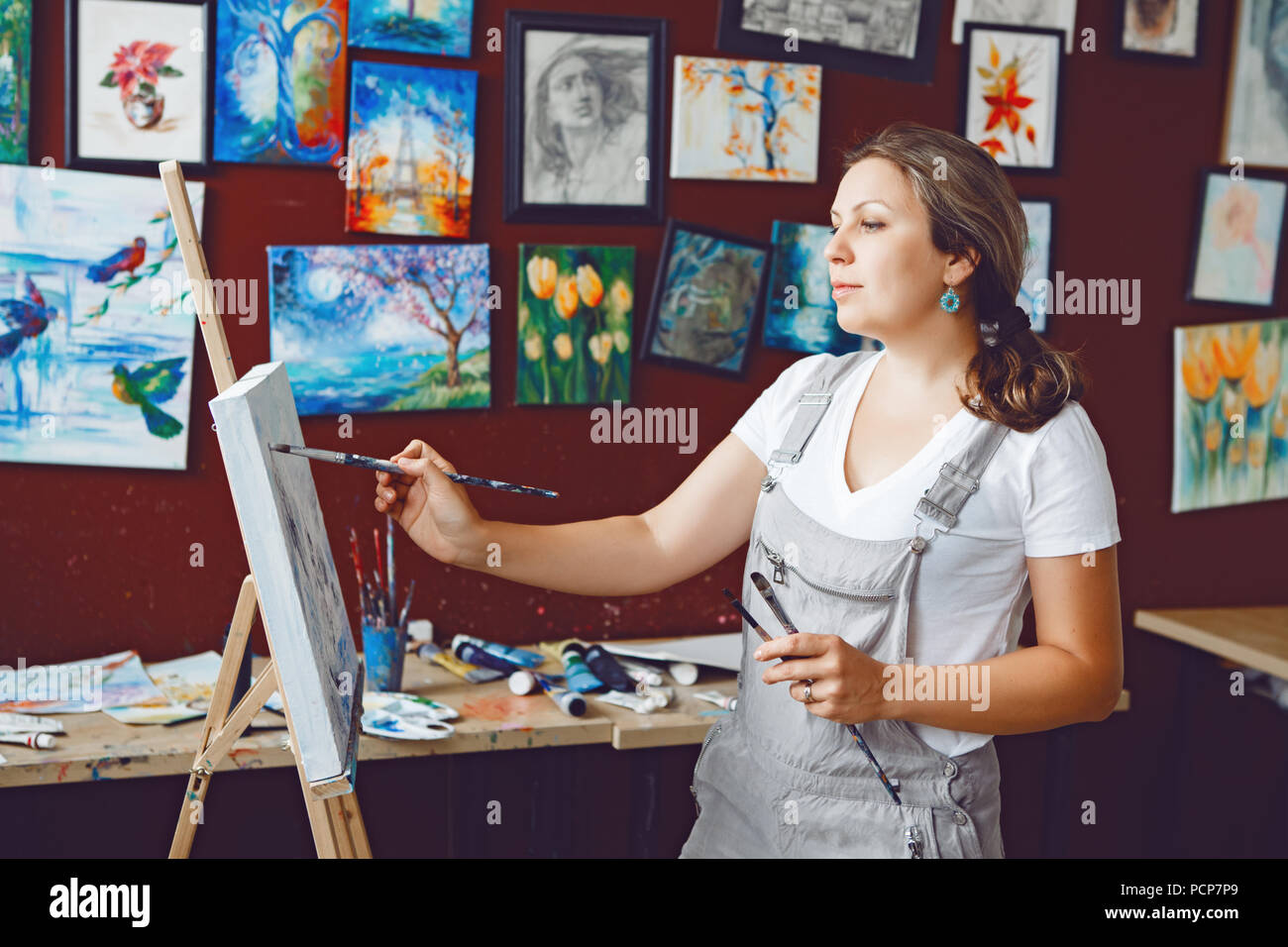 Portrait of young beautiful middle age white Caucasian woman artist ...