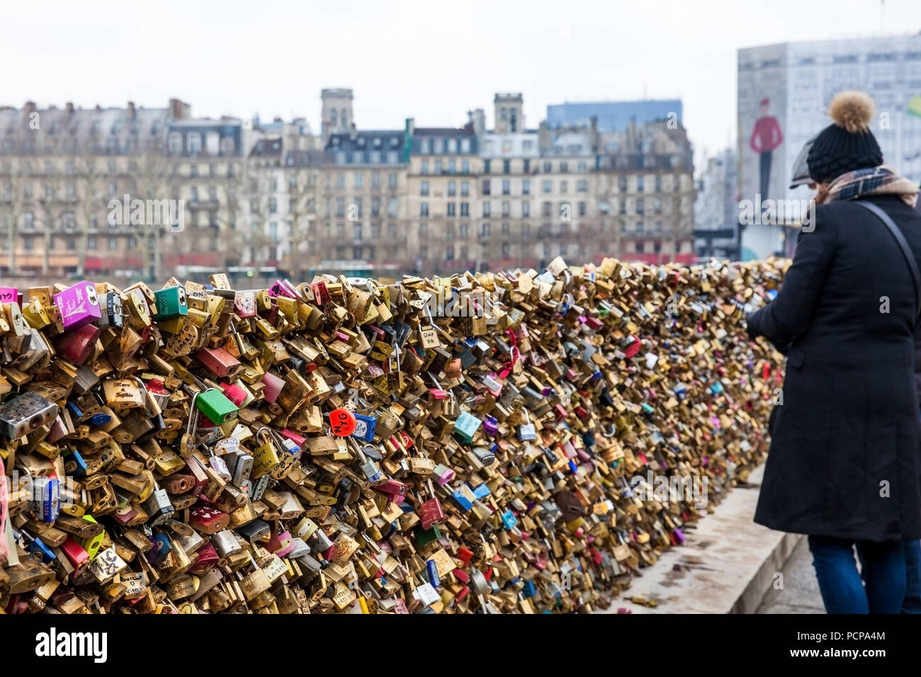 PARIS, FRANCE - MARCH, 2018: Couple watching the love locks at Pont ...