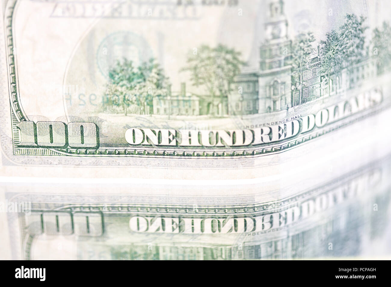 blurred dollar money background and mirror like concept of success ...