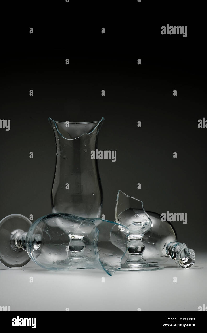 Dangerous still life with three empty modern broken / shattered glasses ...