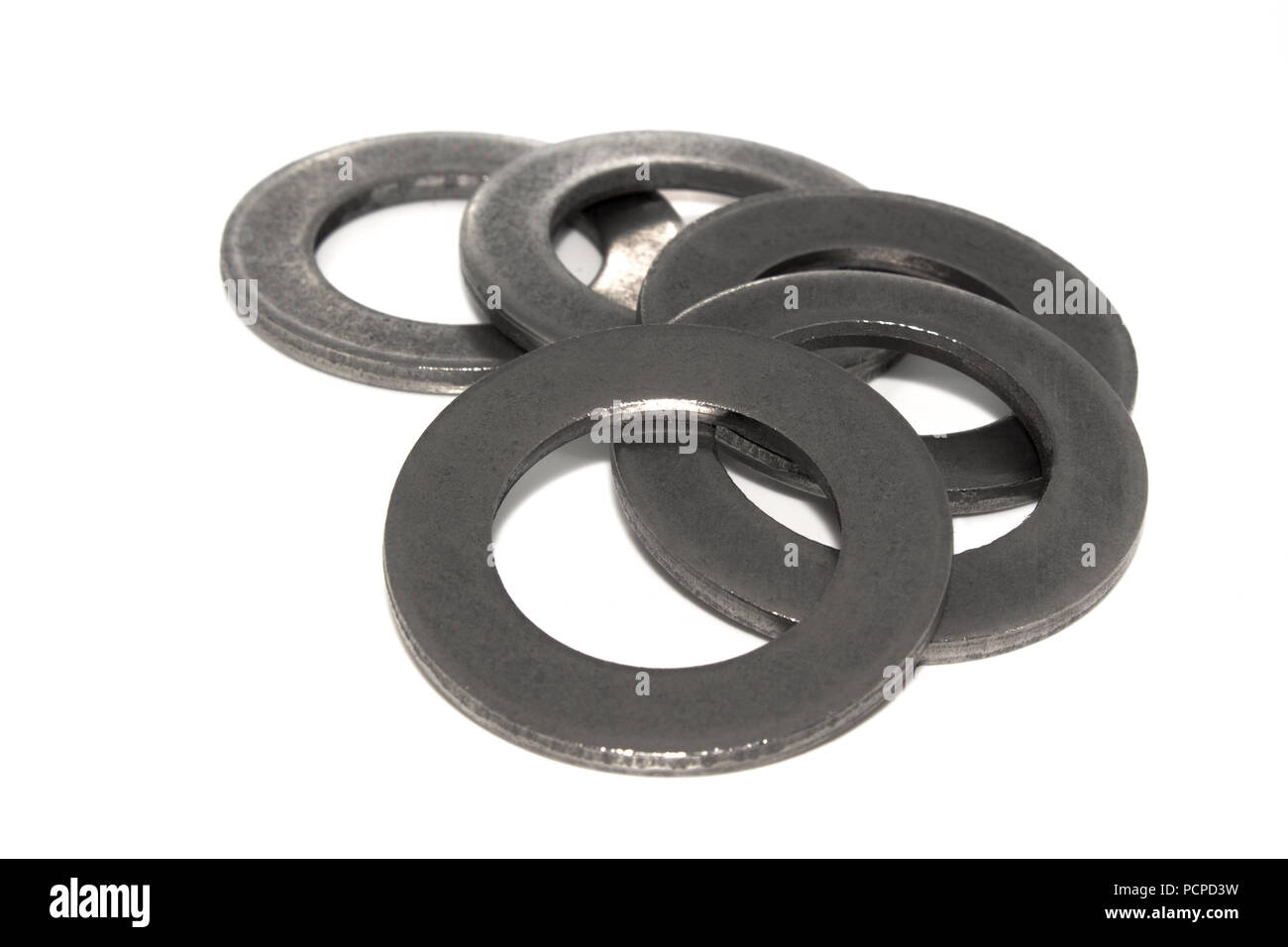 A few big industrial galvanized steel washers on white background Stock ...