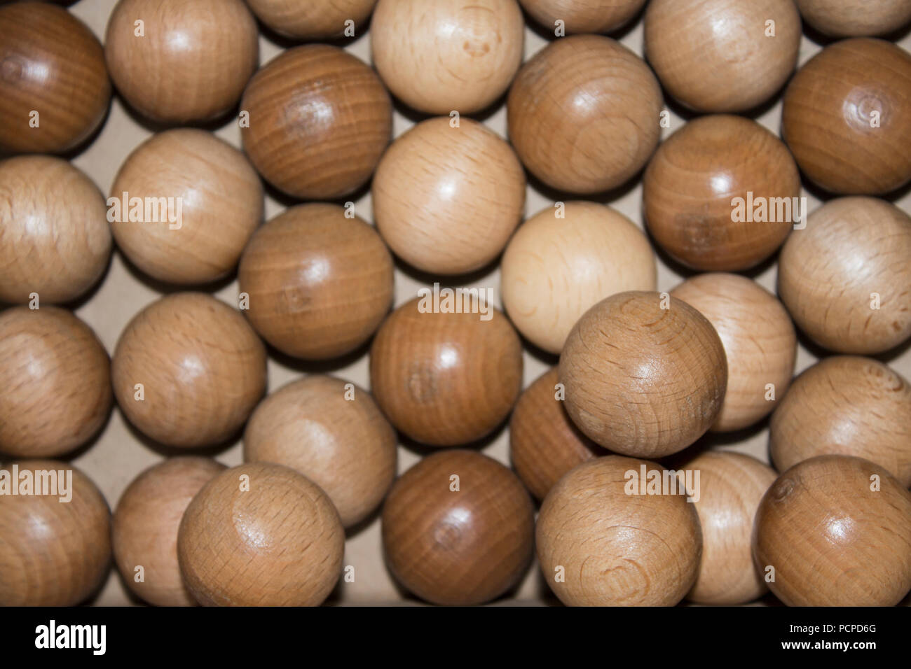 Grid of lots of wooden balls in a cardboard box Stock Photo - Alamy