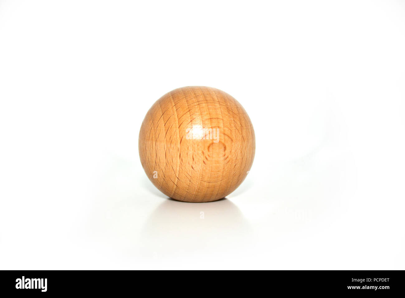 One single round wooden ball on a white background Stock Photo - Alamy