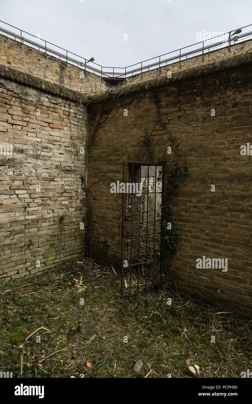 Unkempt Courtyard of an Old Prison Full of Weeds and Cells Stock Photo ...