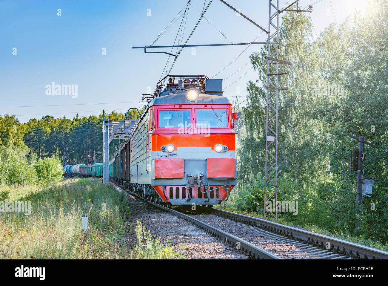 Long freight train approaches to the station Stock Photo - Alamy