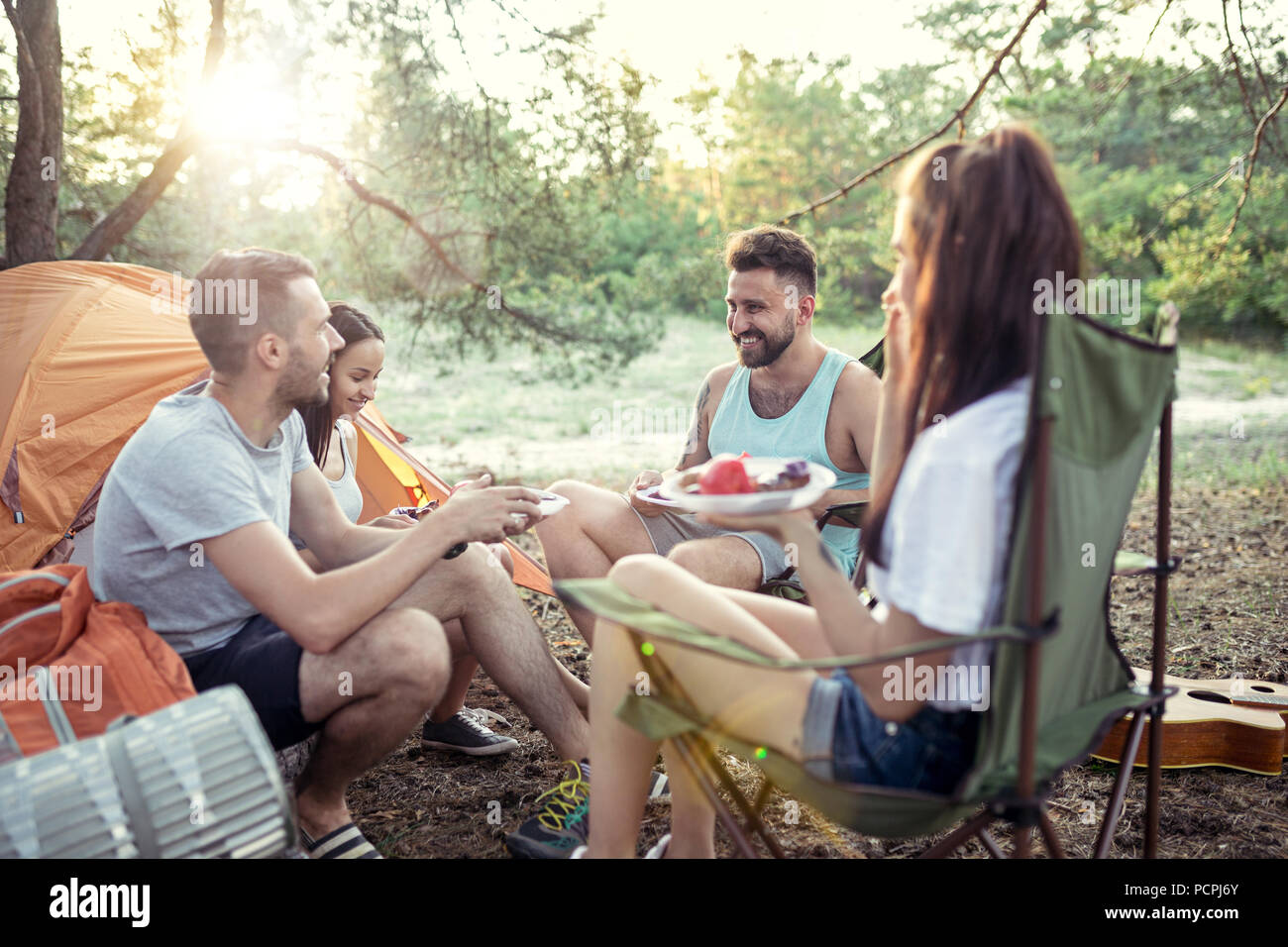 Party, camping of men and women group at forest. They relaxing and ...