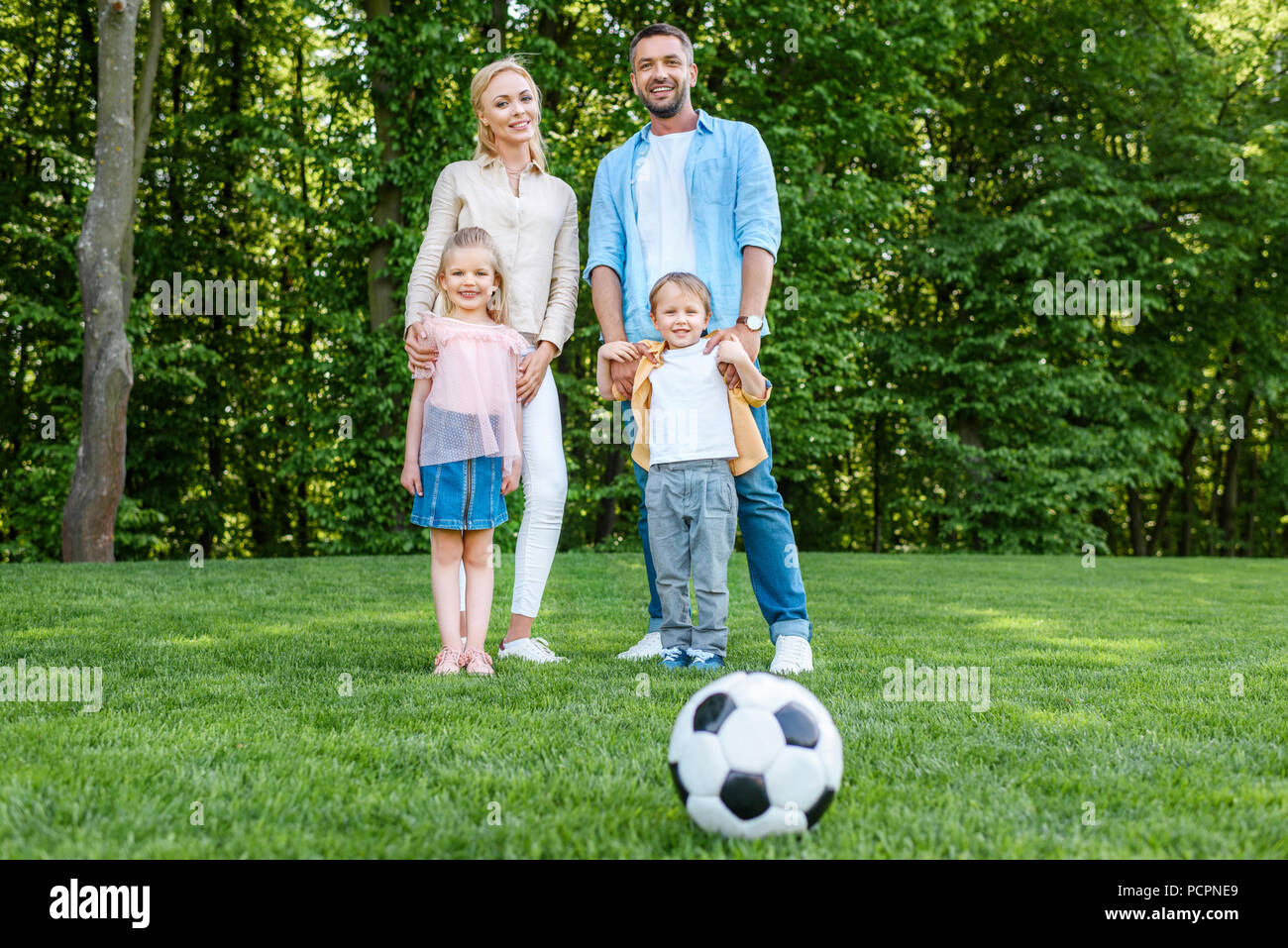 Family kids play soccer together hi-res stock photography and images ...