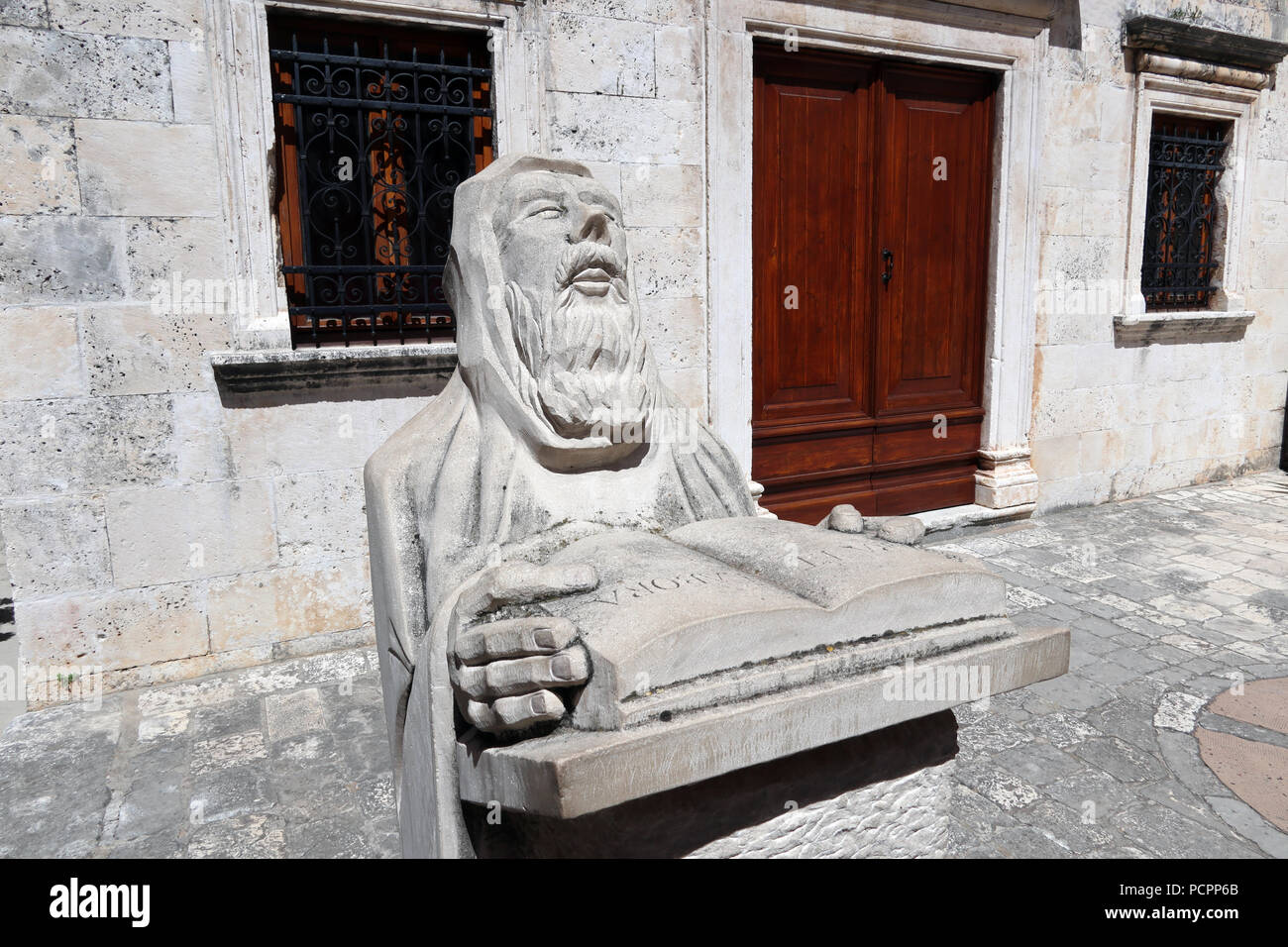 Statue of St. Anthony the Abbot reading the bible, outside the ...