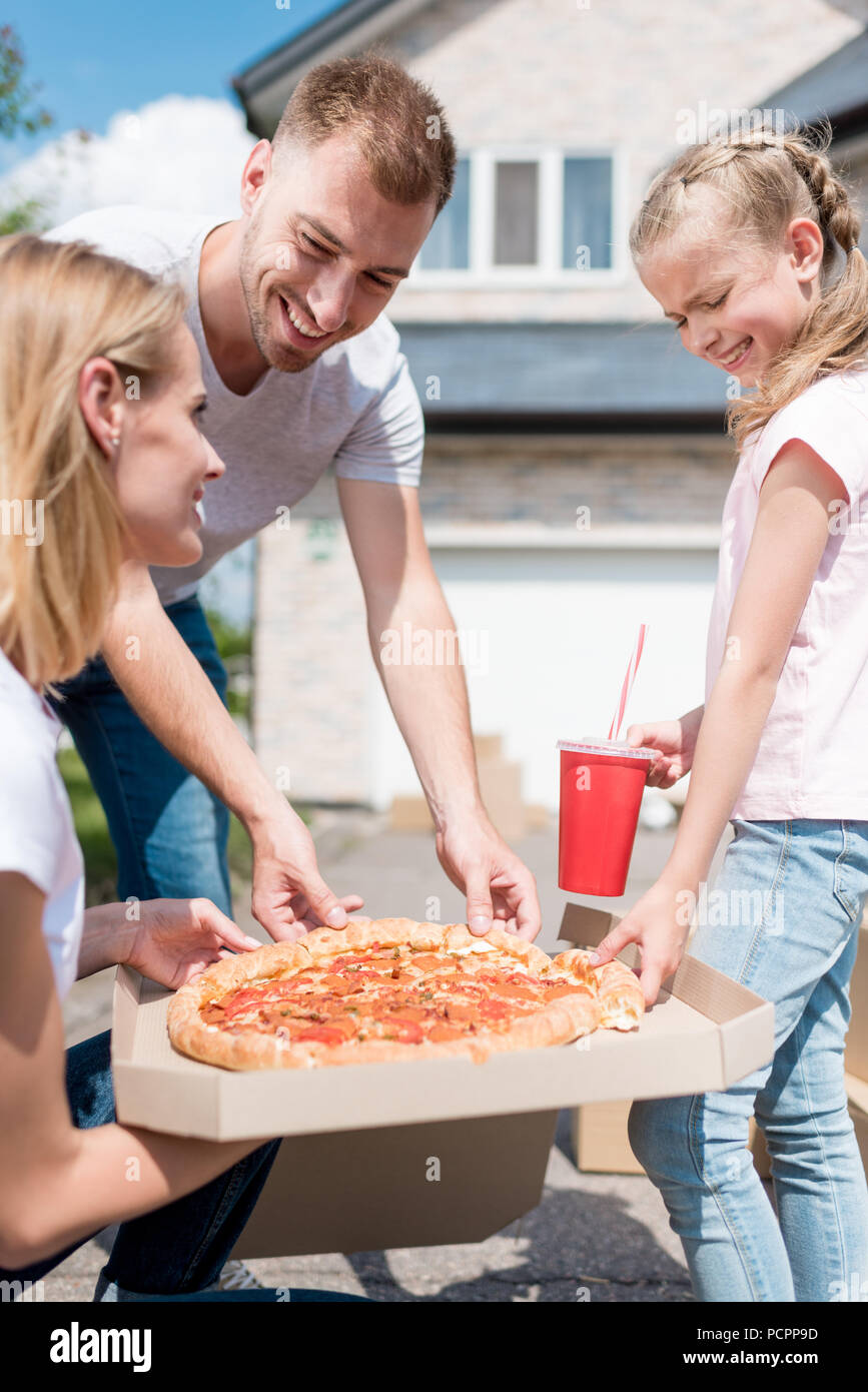 happy family with daughter preparing to eat pizza Stock Photo - Alamy