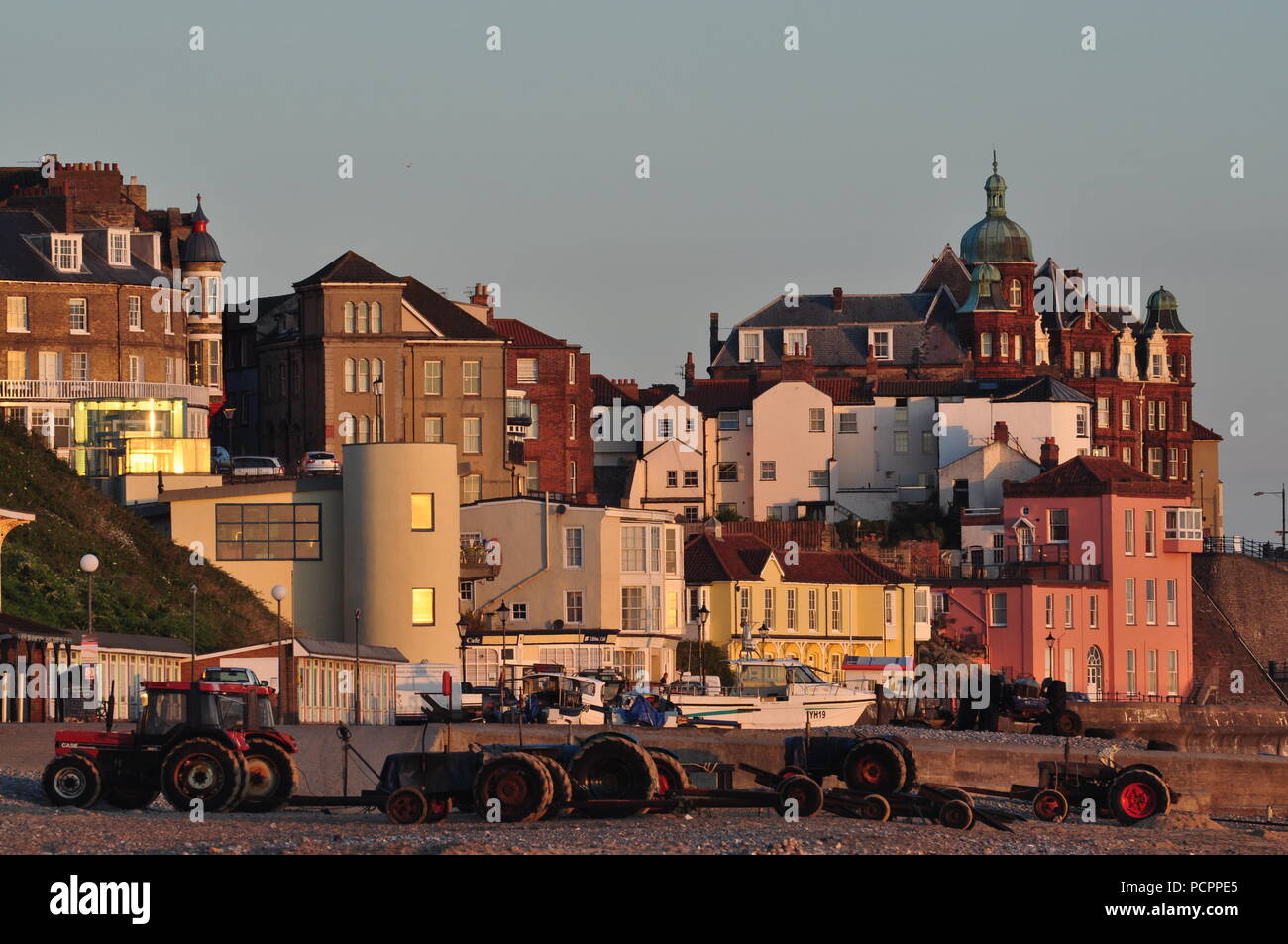 Cromer seafront with crab boat trailers and tractors in early summer ...