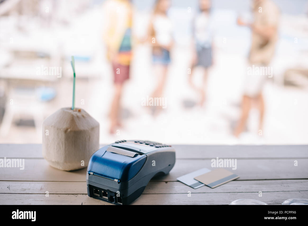 close-up view of summer cocktail with drinking straw and payment ...
