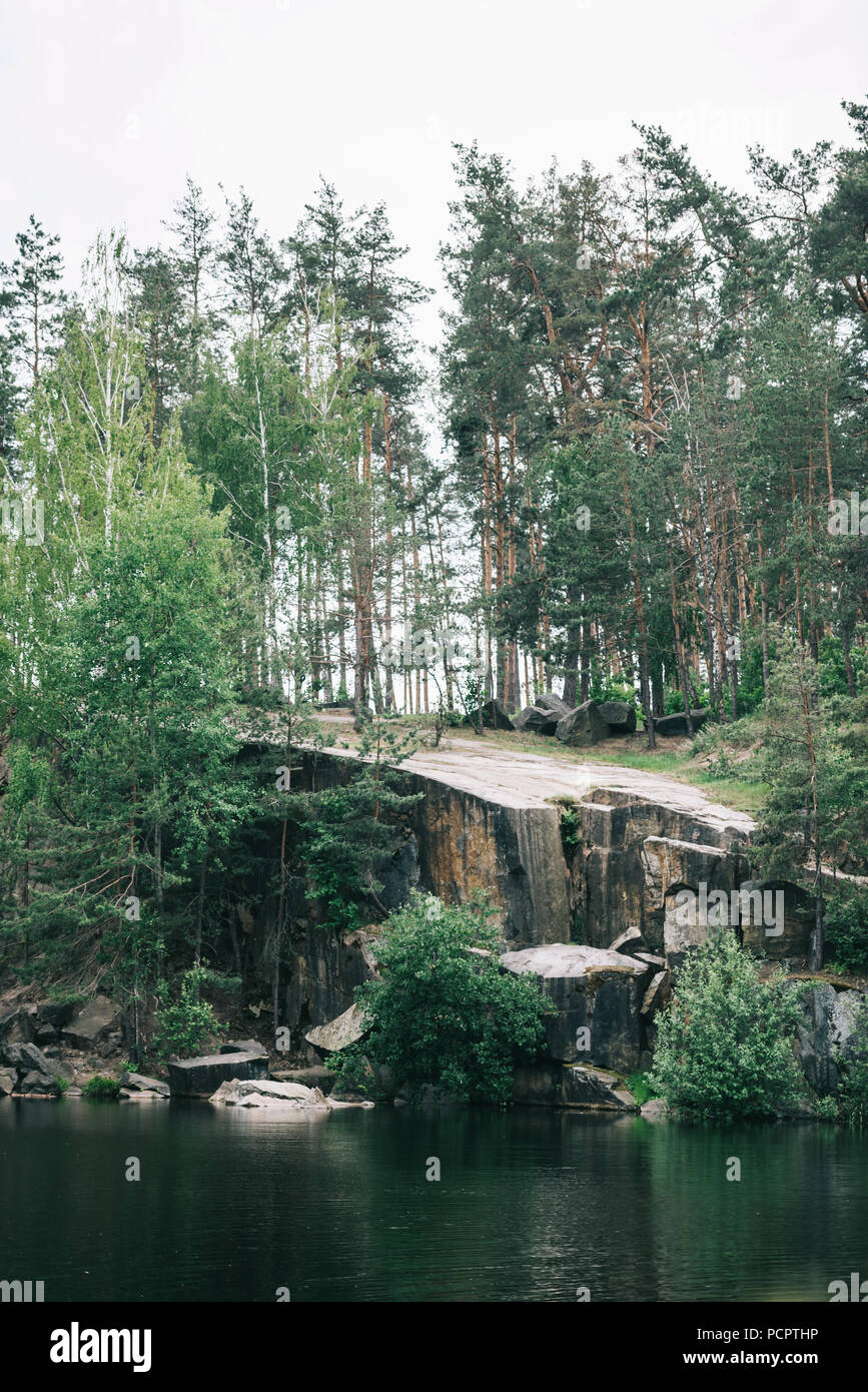 Forest on cliff over lake hi-res stock photography and images - Alamy