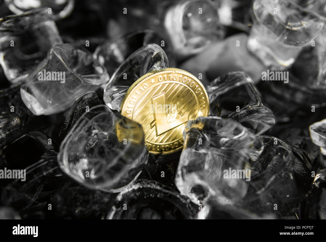 Gold litecoin coin on ice background. Mining litecoins. The concept of ...