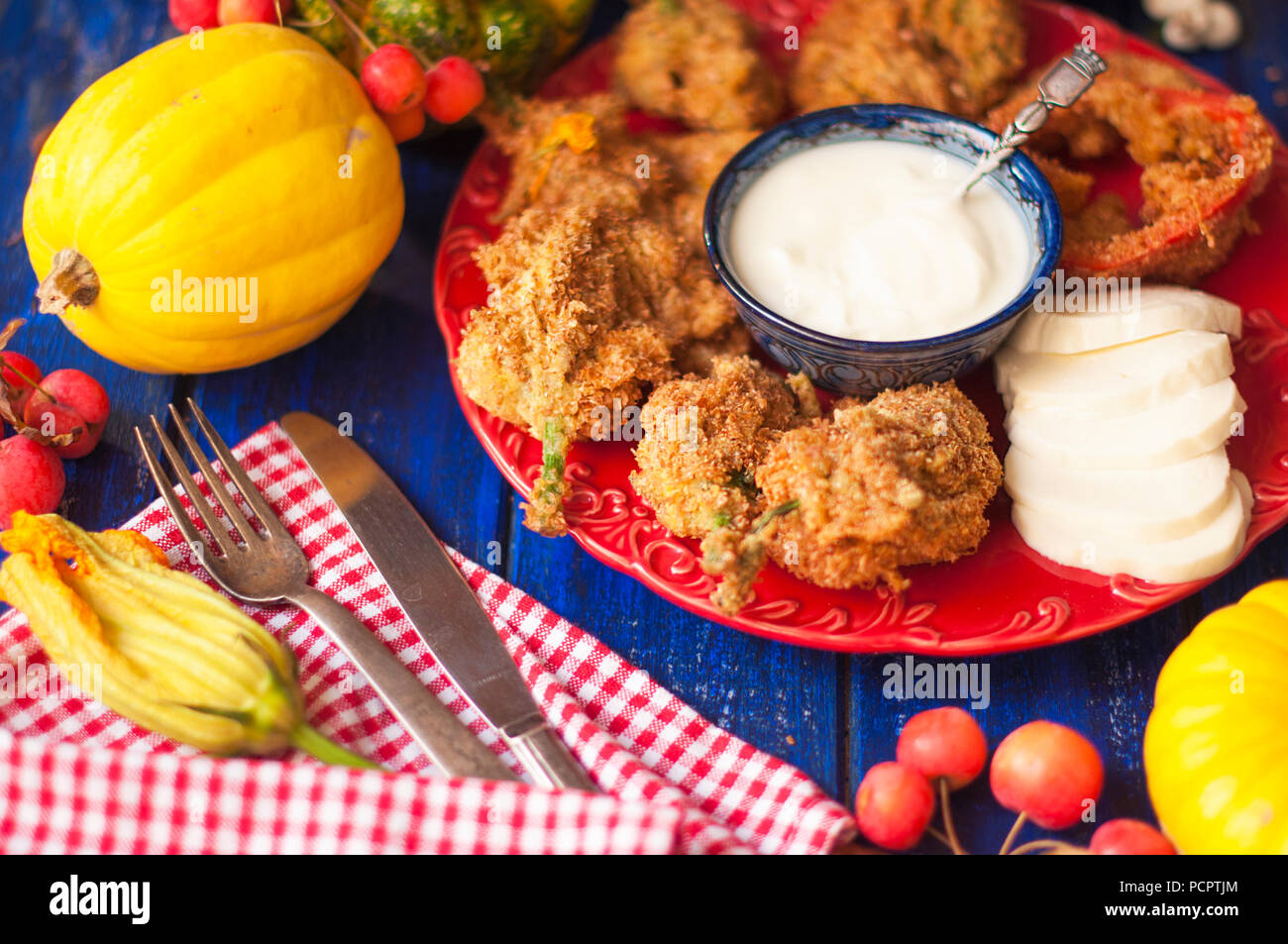 Baked pumpkin flowers with mozzarella cheese and in batter. Traditional ...