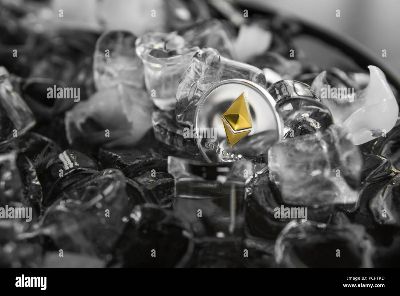 Digital crypto currency physical metal gold Ethereum coin on ice ...