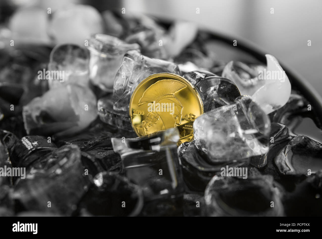 Gold Titan coin on ice background. Blockchain mining. Digital money and ... Gold Titan coin on ice background. Blockchain mining. Digital money and ...