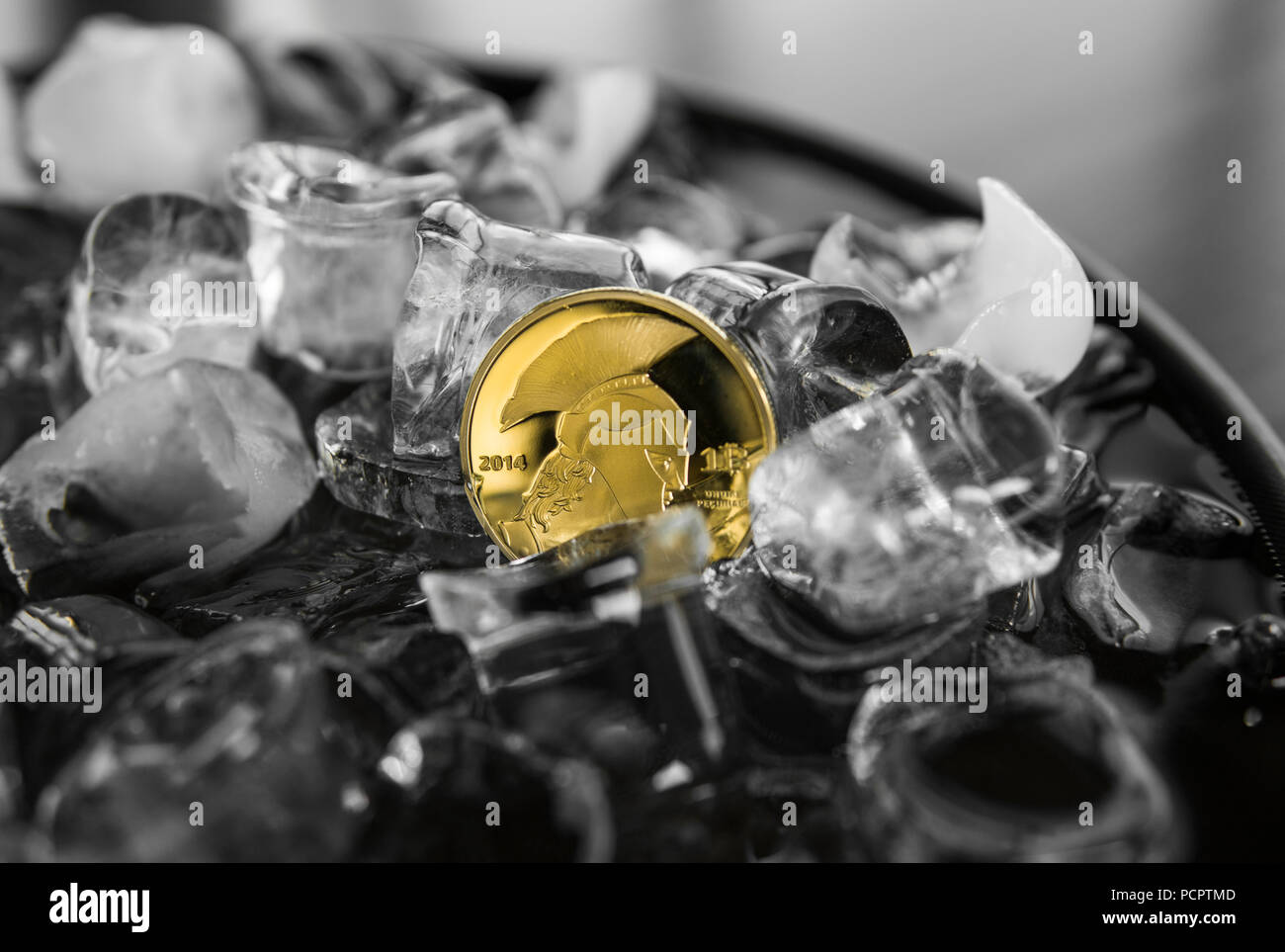 Gold Titan coin on ice background. Blockchain mining. Digital money and ... Gold Titan coin on ice background. Blockchain mining. Digital money and ...