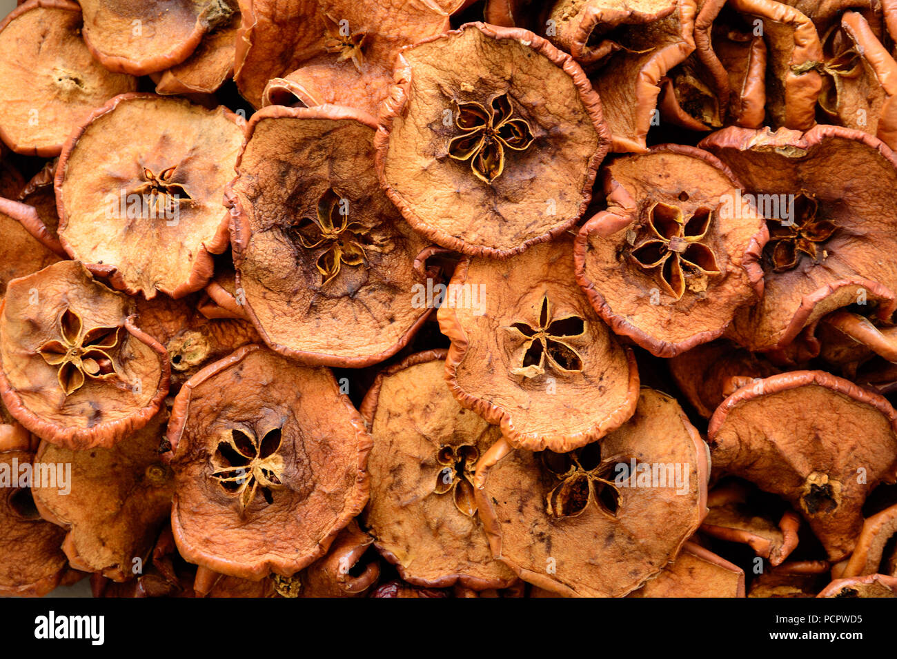 Homemade sun-dried organic apple slices (crispy apple chips) background ...