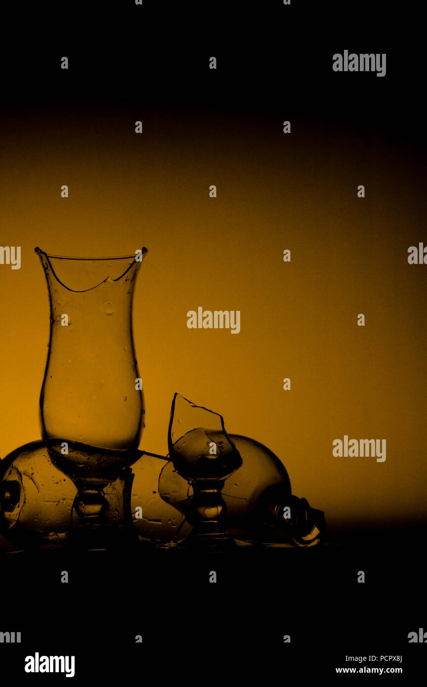 Dangerous still life with three empty modern broken / shattered glasses ...