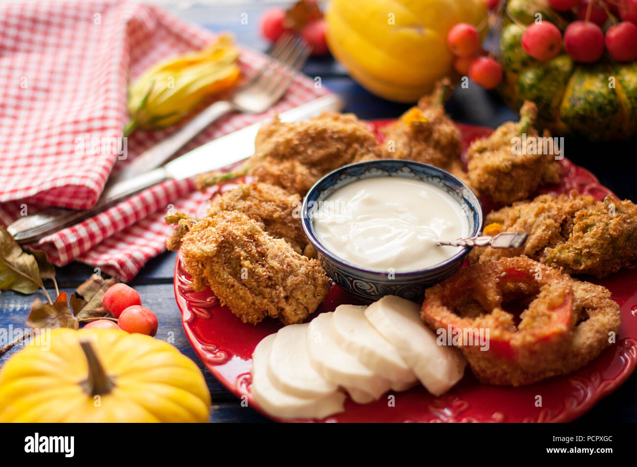 Baked pumpkin flowers with mozzarella cheese and in batter. Traditional ...