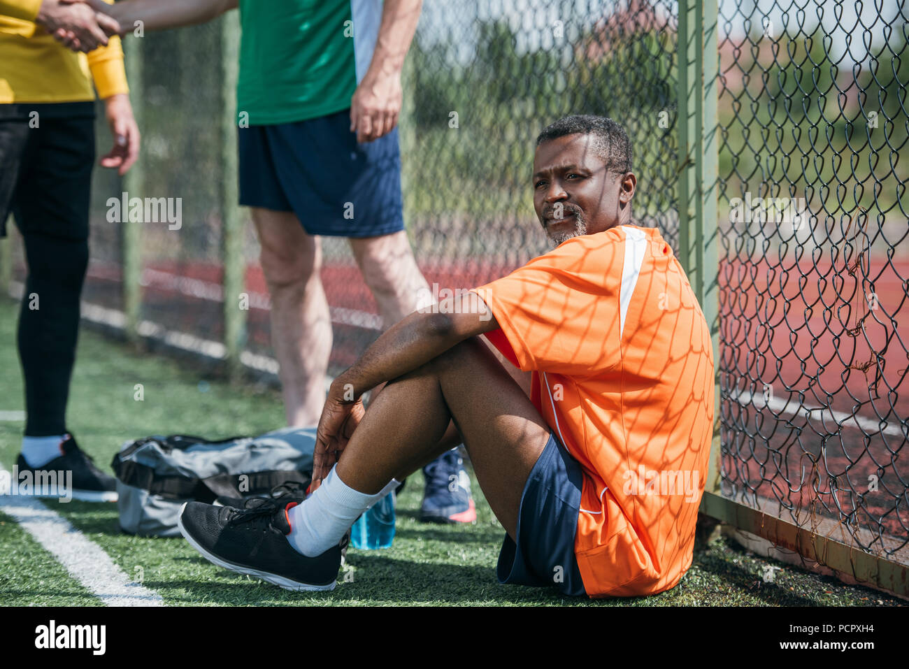 selective focus of elderly african american man resting on football ...