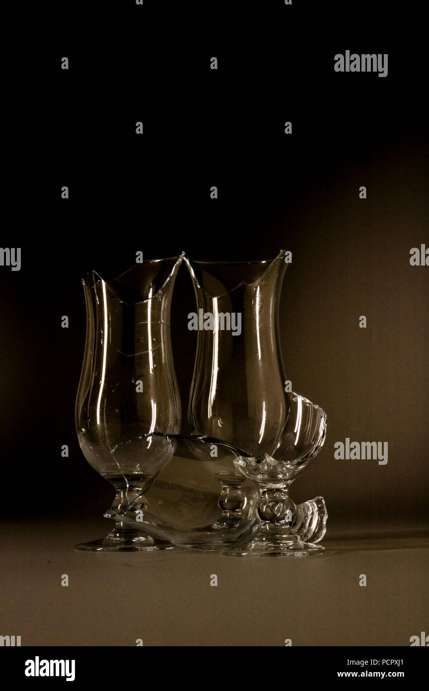 Dangerous still life with three empty modern broken / shattered glasses ...