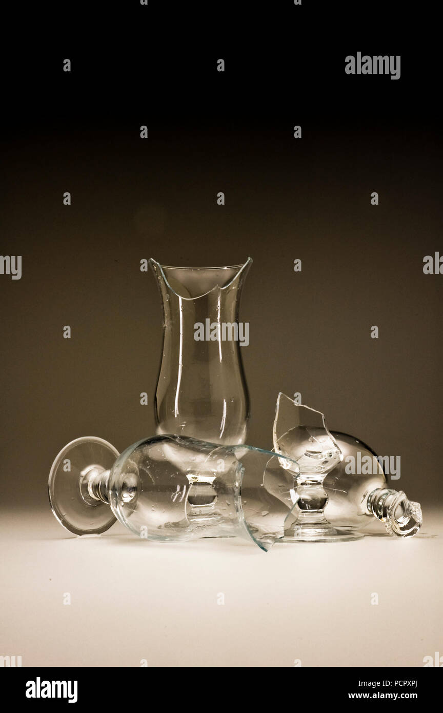 Dangerous still life with three empty modern broken / shattered glasses ...