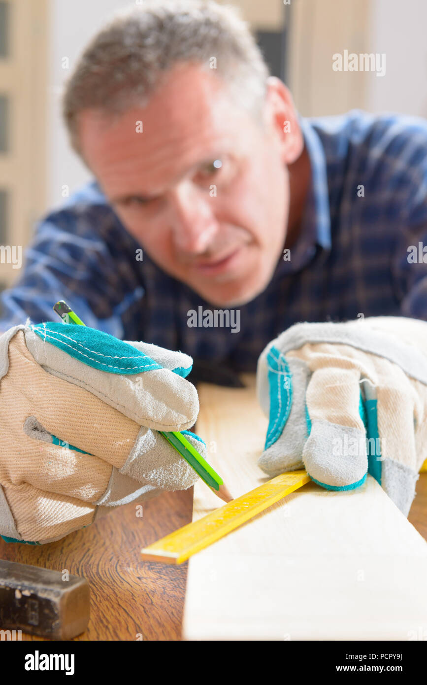 Handyman measuring furniture measuring tape hi-res stock photography ...