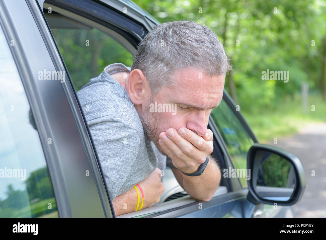 Man suffering from motion sickness in a car Stock Photo - Alamy