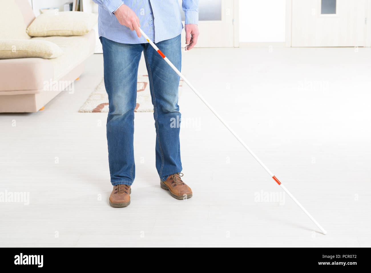 Blind man with white stick at home Stock Photo - Alamy
