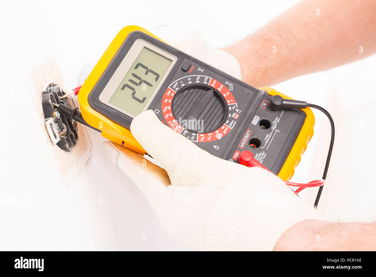 Electrician checking socket voltage with digital multimeter Stock Photo ...