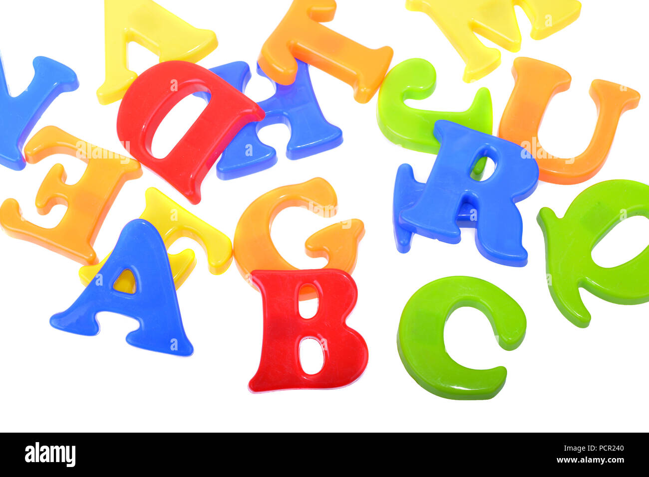 Close up of plastic letters showing ABC isolated on a white background ...