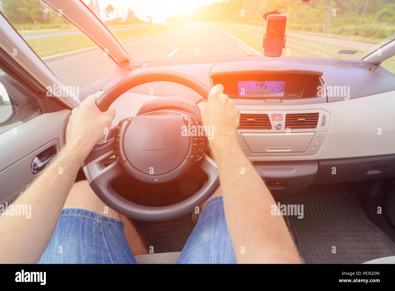 Driving a car - first person view. Hands on steering wheel Stock Photo ...