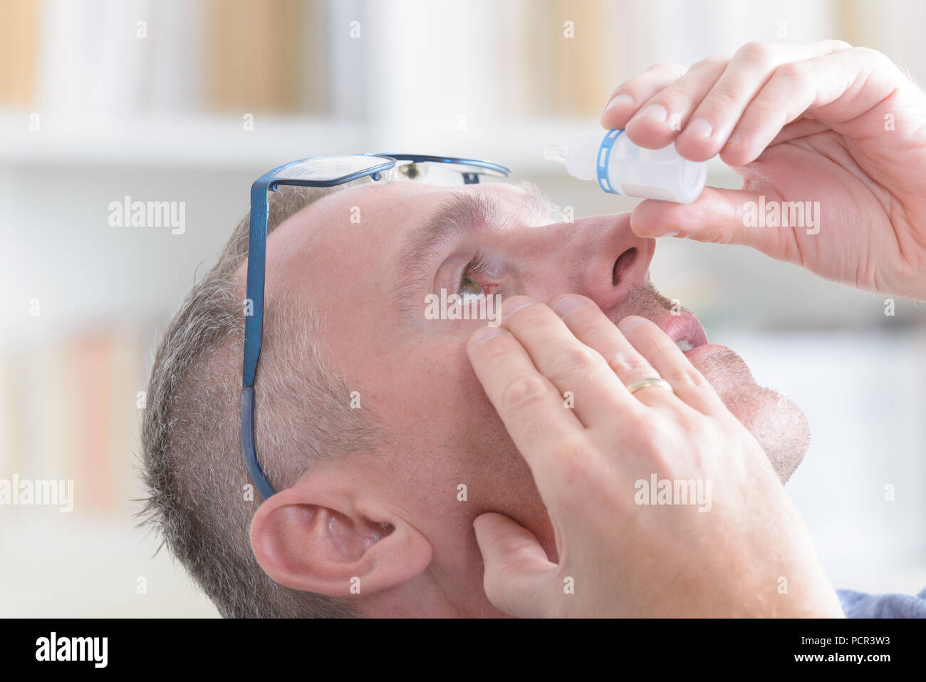 Applying eye drops hi-res stock photography and images - Alamy