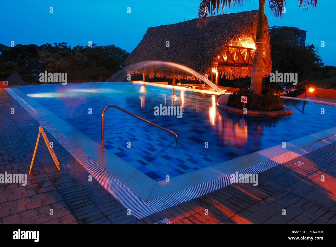 Resort swimming pool shot at night Stock Photo - Alamy