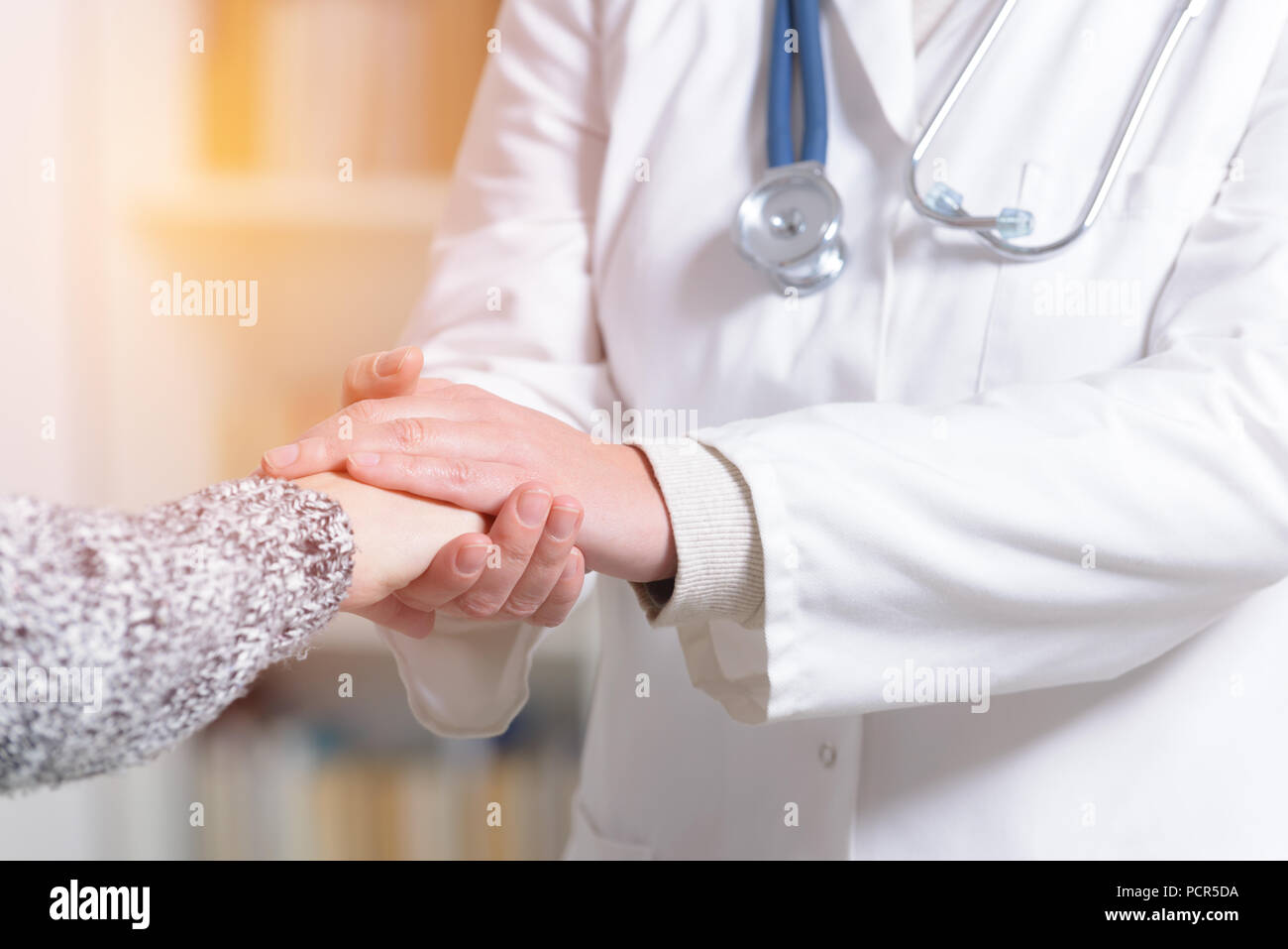 Doctor holding patient's hand hospital hi-res stock photography and ...