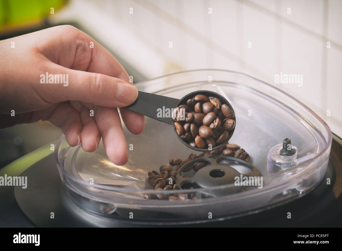 Adding coffee beans to the built in grinder in the coffee maker Stock ...